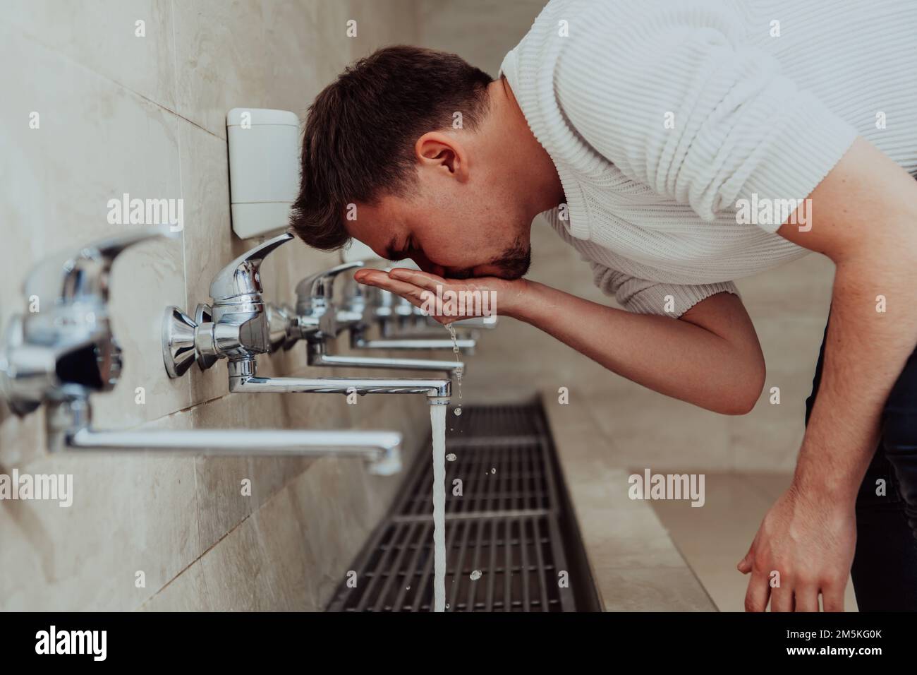 A Muslim performing ablution. Ritual religious cleansing of Muslims ...
