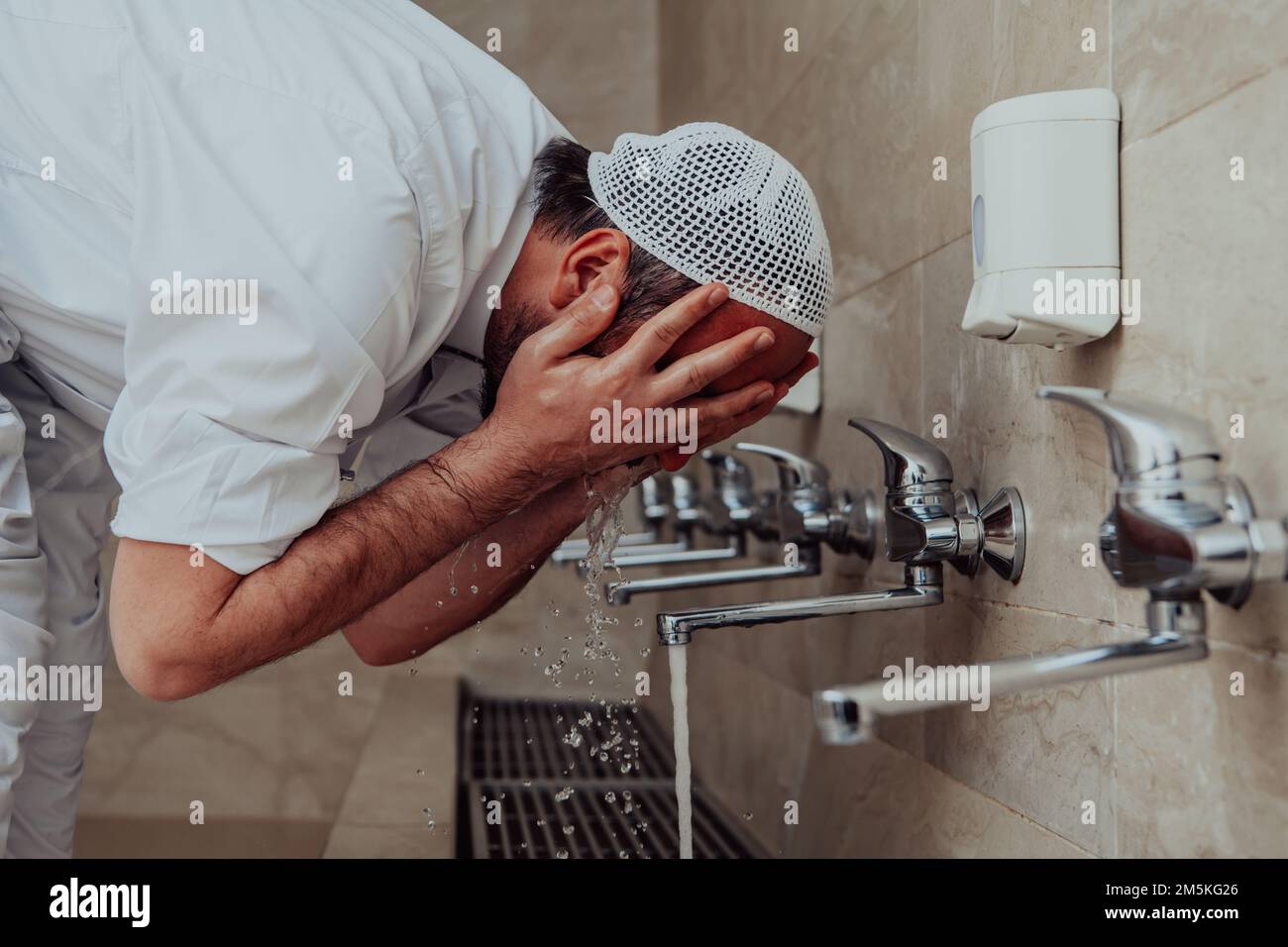 A Muslim performing ablution. Ritual religious cleansing of Muslims ...