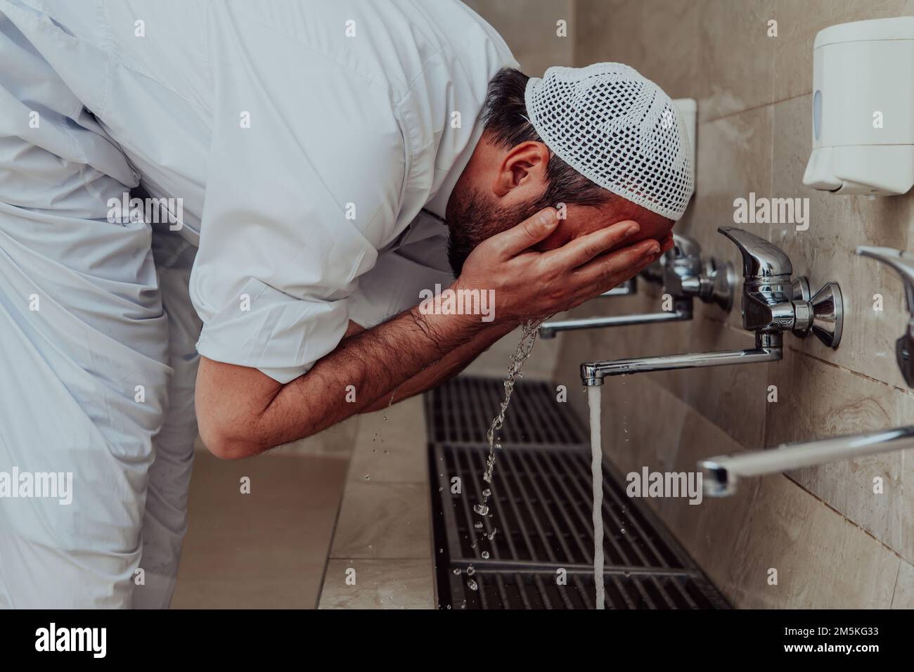 A Muslim performing ablution. Ritual religious cleansing of Muslims ...