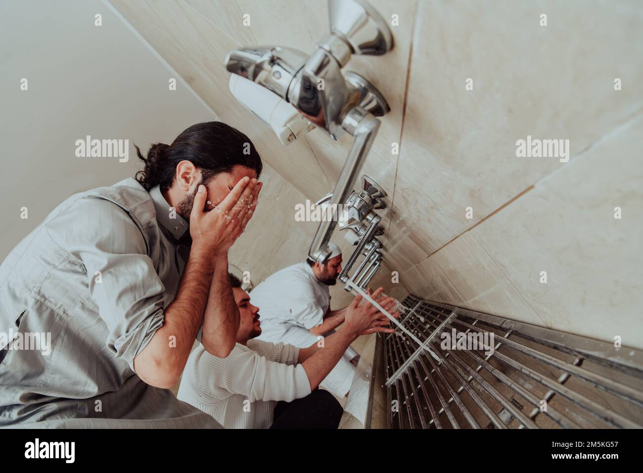 A Muslim performing ablution. Ritual religious cleansing of Muslims ...
