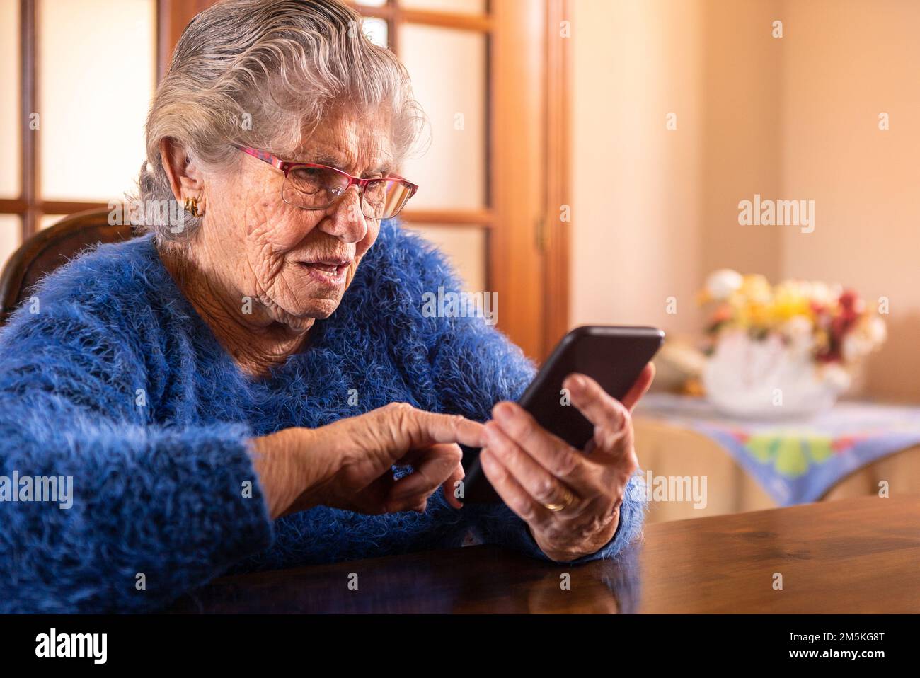 Woman table holds smartphone touching hi-res stock photography and ...