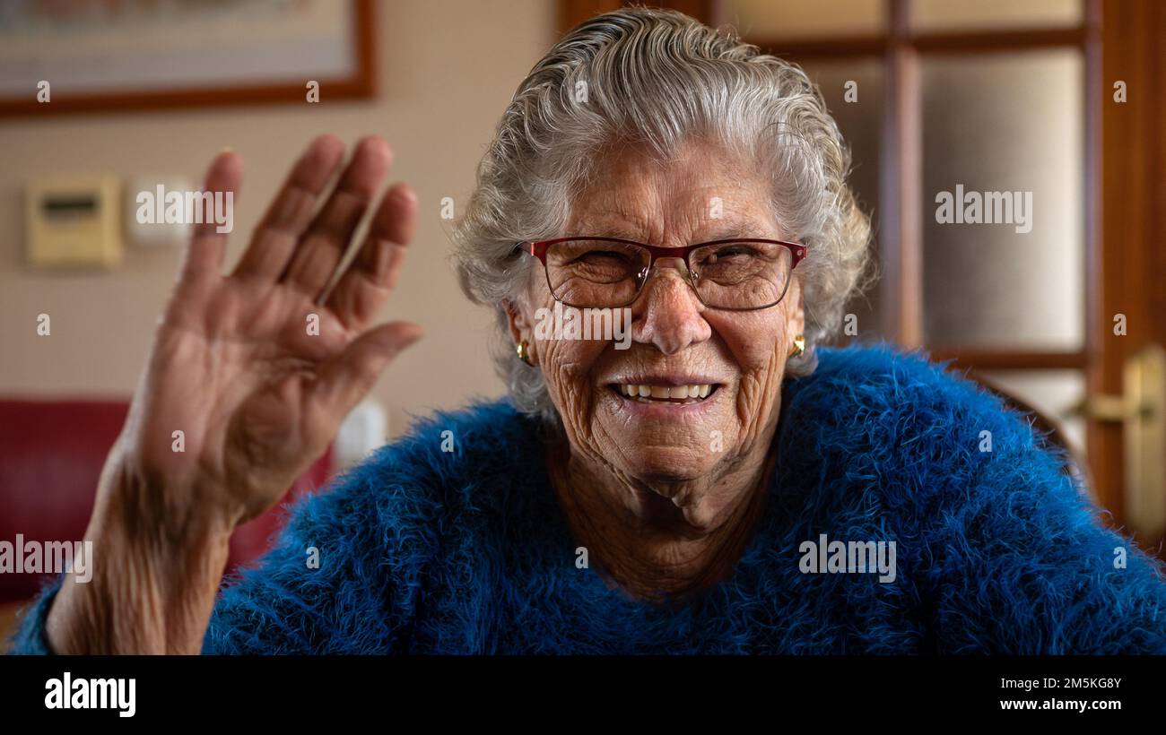 Portrait of happy excited caucasian 90s woman enjoying video call talk ...