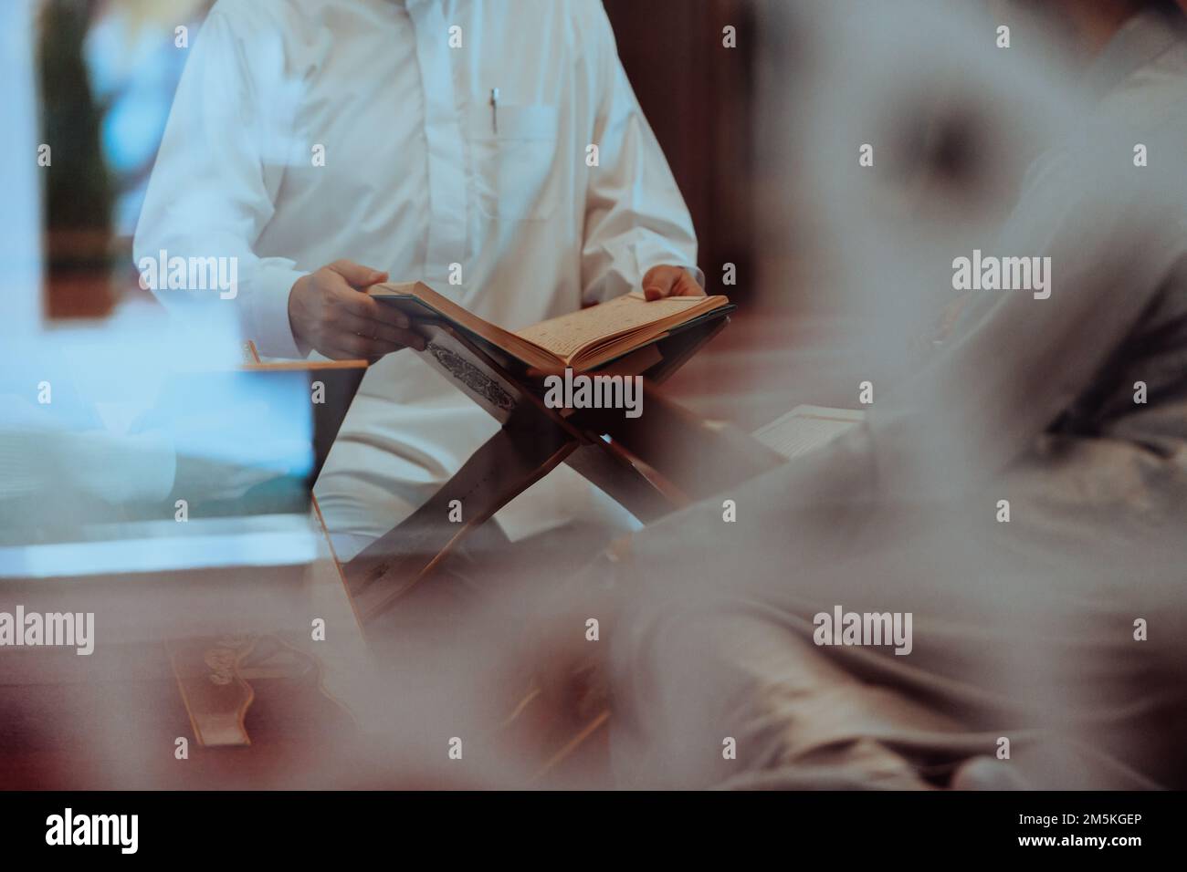 A group of Muslims reading the holy book of the Quran in a modern ...