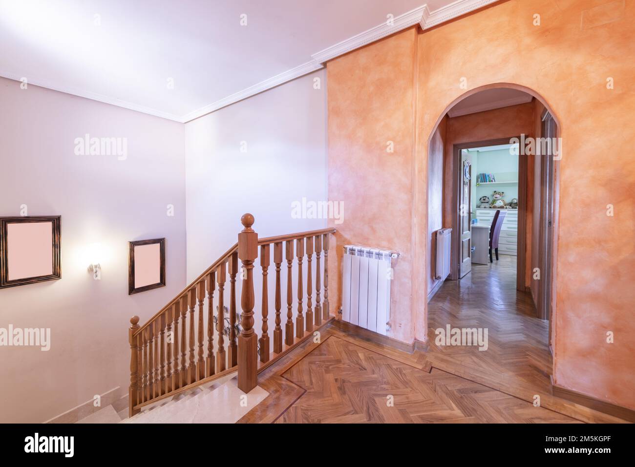 Stairs of a detached house with cream marble stairs and wooden railing ...