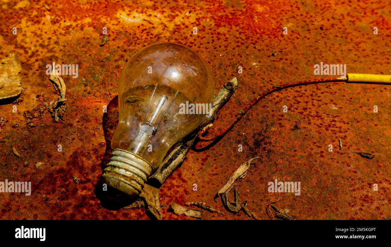 Light bulb on rusty zinc as background Stock Photo - Alamy
