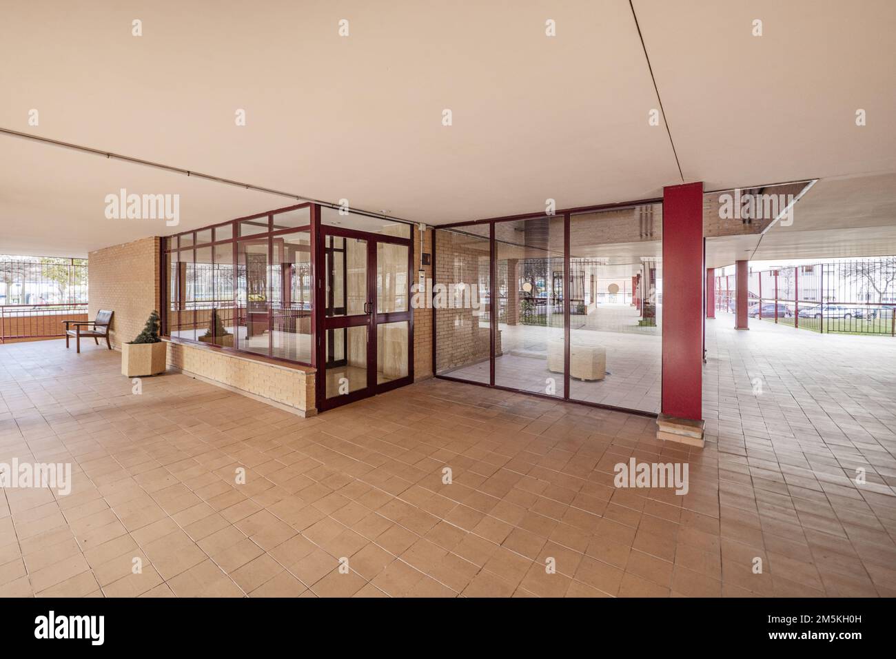 Common areas of an urbanization with red-painted metal and glass ...