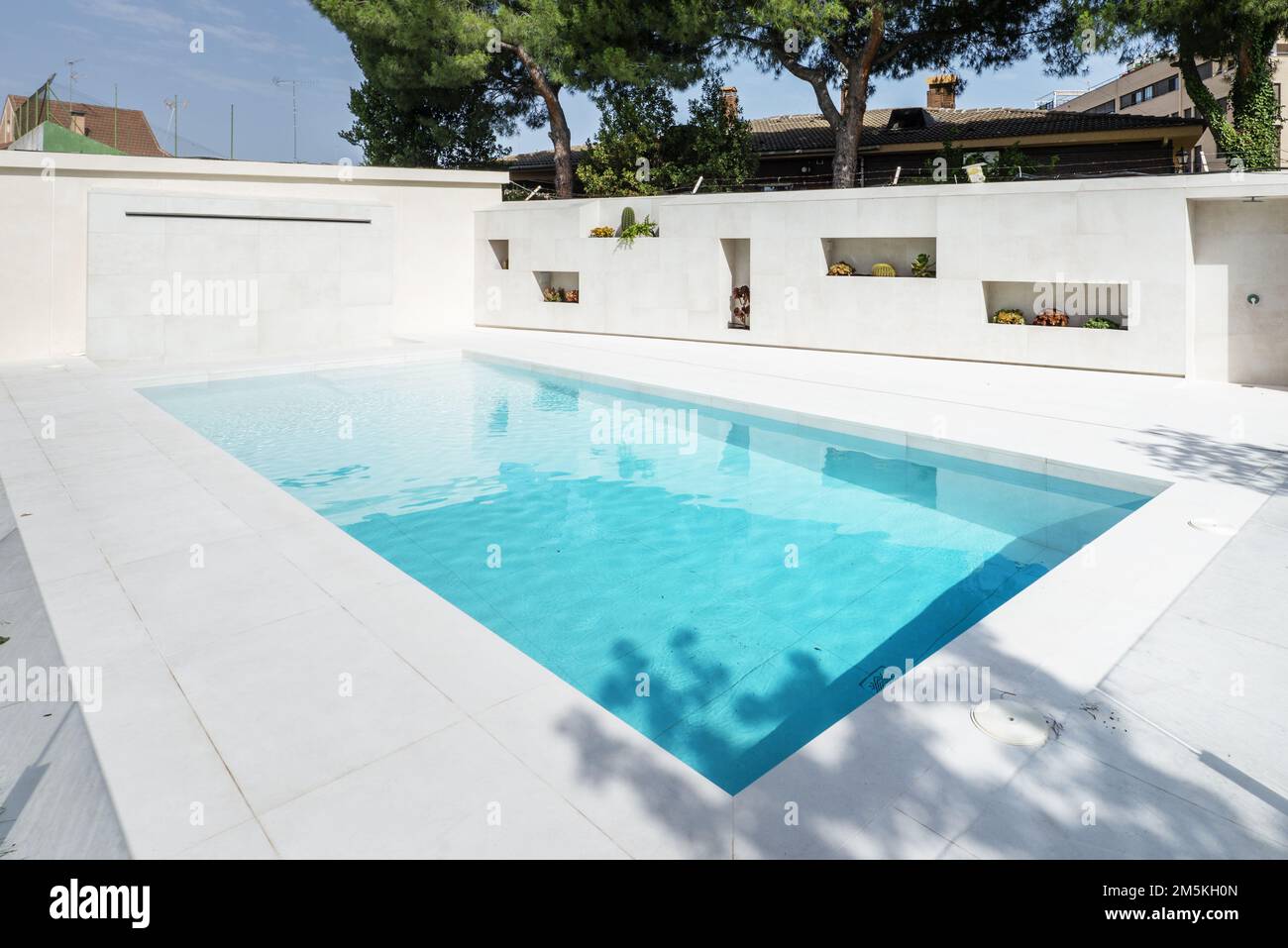 A white marble pool filled with inviting chlorinated water, a garden ...