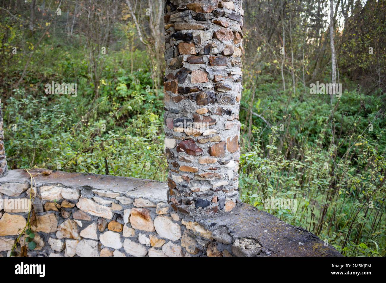 Park gazebo with columns built of wild raw stone - flint and limestone ...