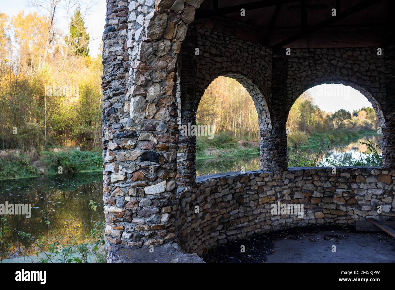 Park gazebo with columns built of wild raw stone - flint and limestone ...
