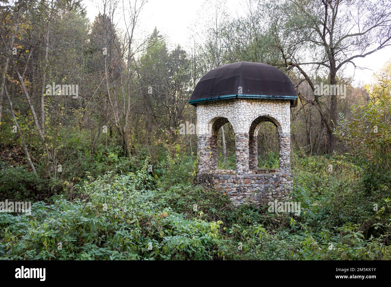 Arbor in the form of a small rotunda built from fragments of stone with ...
