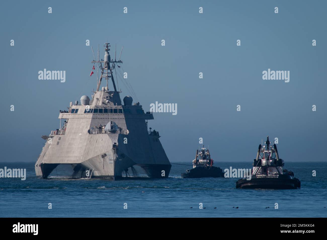 With assistance from two tugboats, USS Kansas City (LCS 22) glides into ...