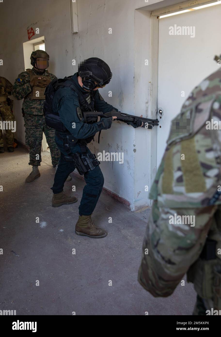 A member of Brcko District Special Police Unit (JSP), aims his shotgun ...