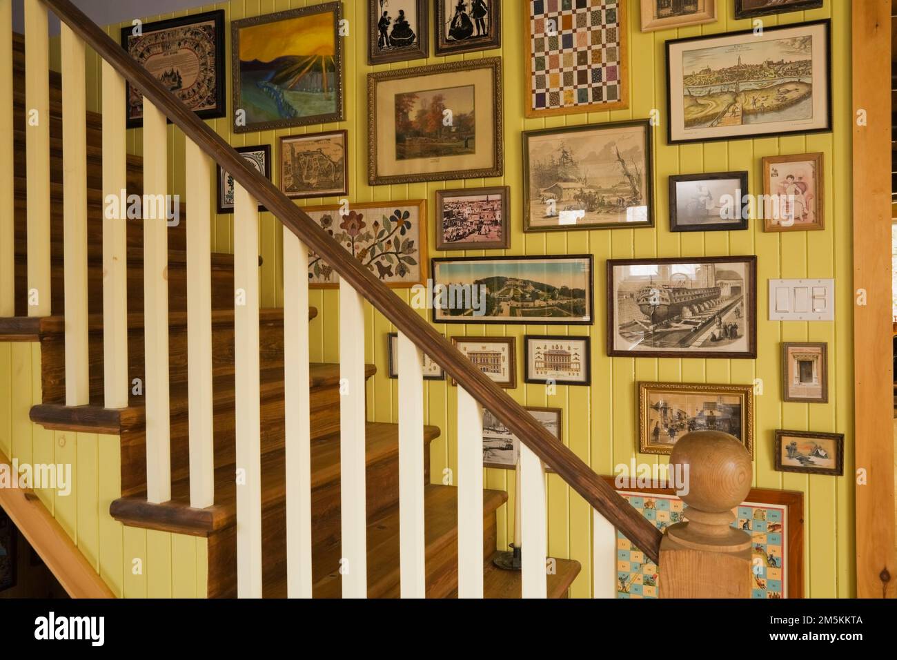 Staircase wall decorated with picture frames in dining room inside ...