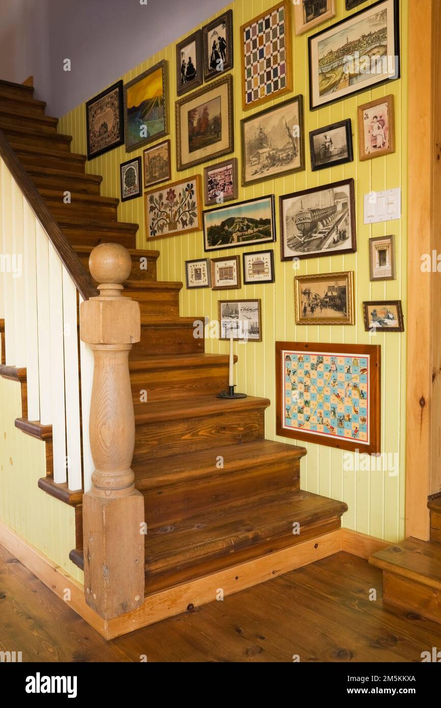 Staircase wall decorated with picture frames in dining room inside ...