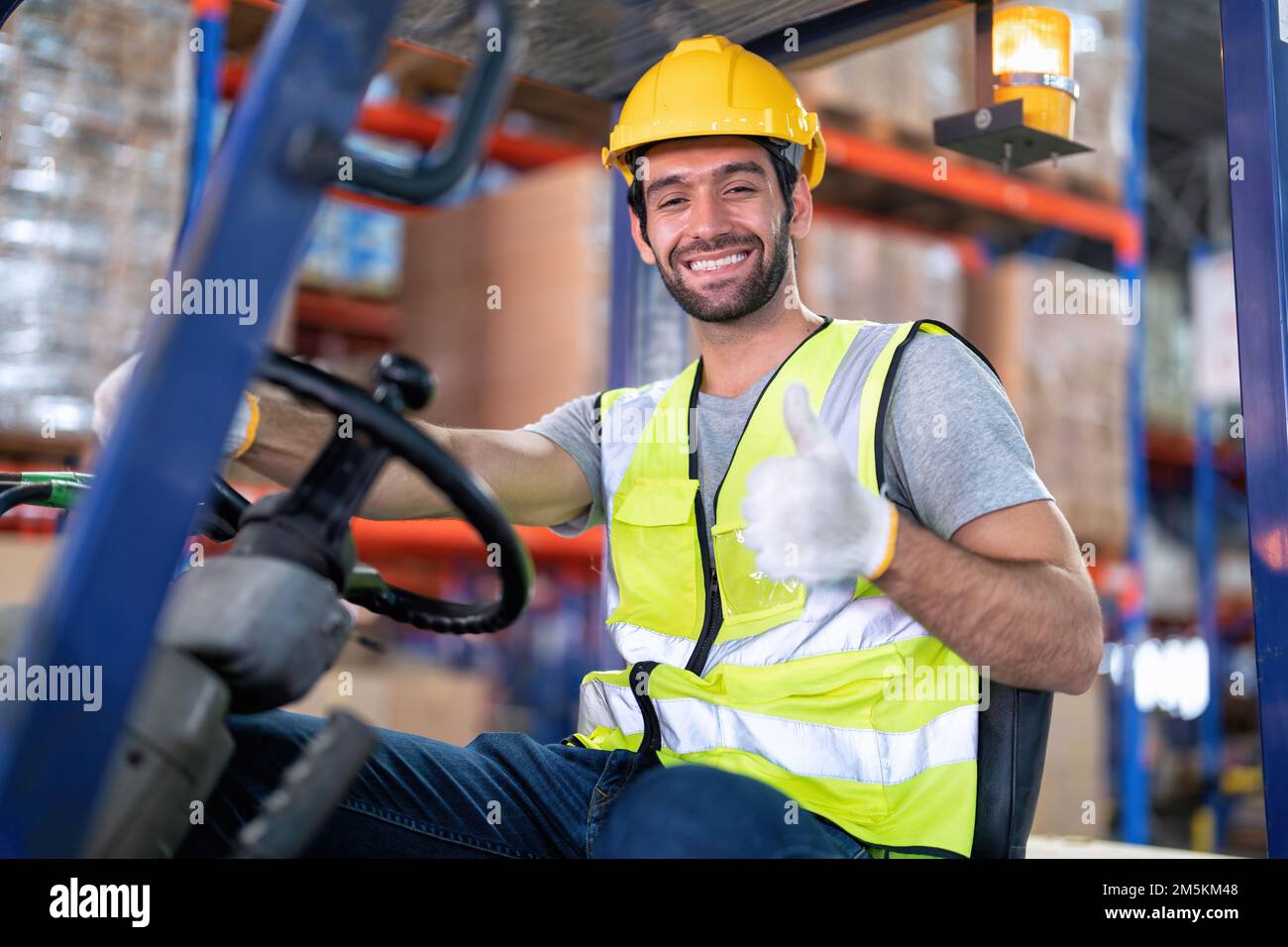Forklift Truck Operator Lifts Pallet Cardboard Boxes On a Shelf by ...