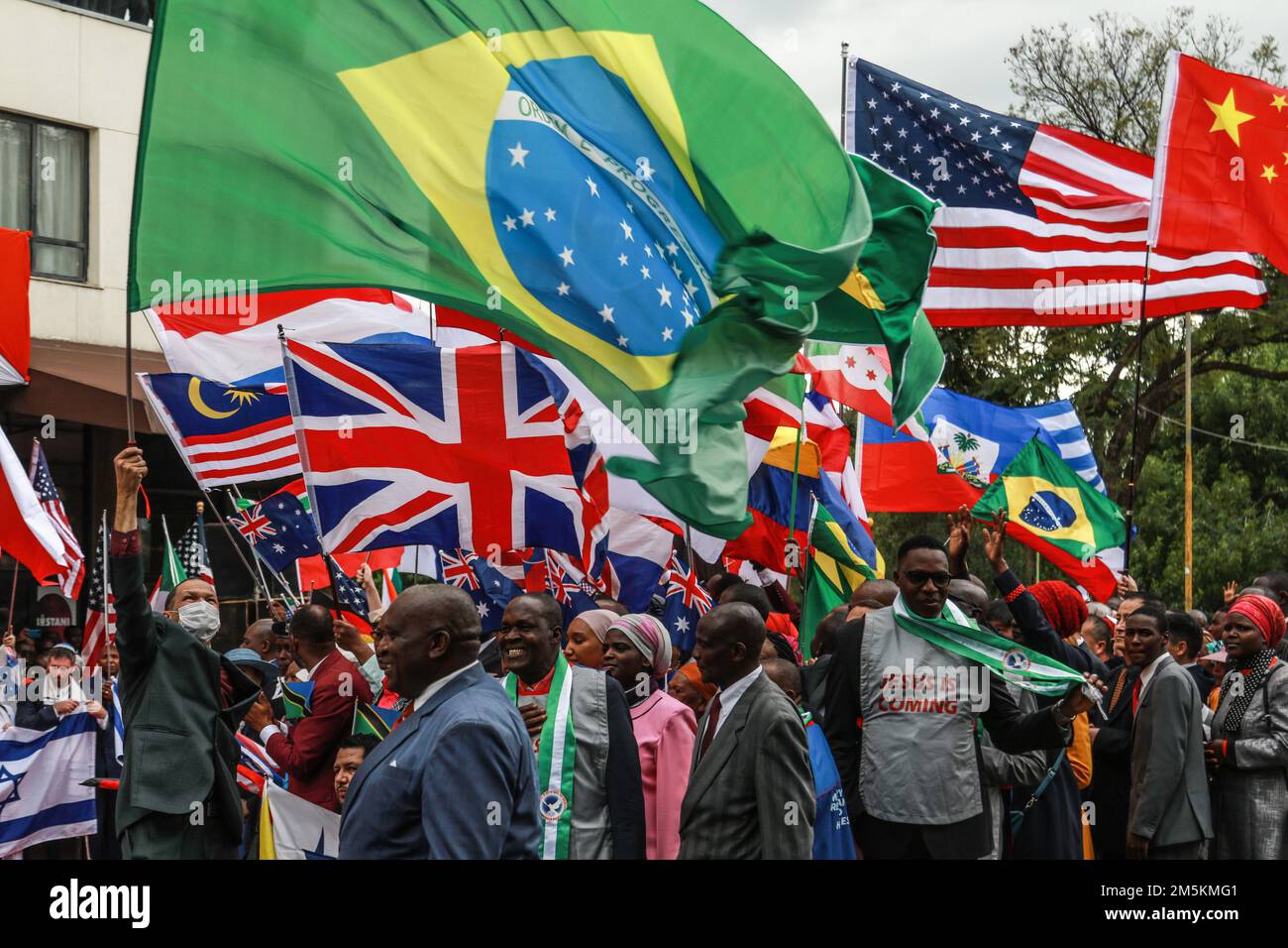 Brazilian flag among flags of other countries is waved by worshippers ...