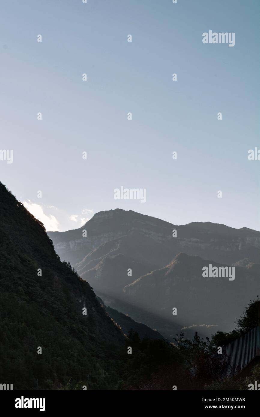 A mountain range with layers and sunlight at sunset, vertical Stock ...