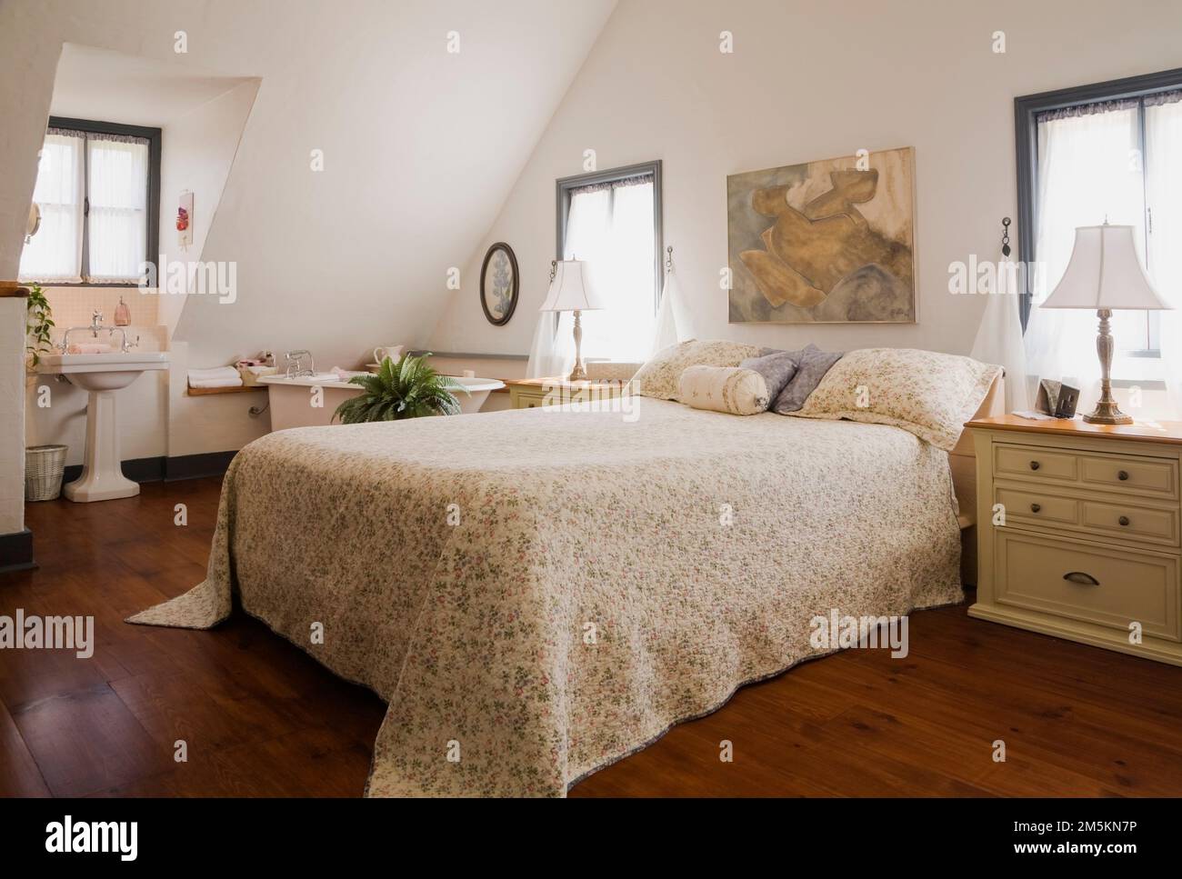 Double bed with flowery bedspread in master bedroom on upstairs floor ...