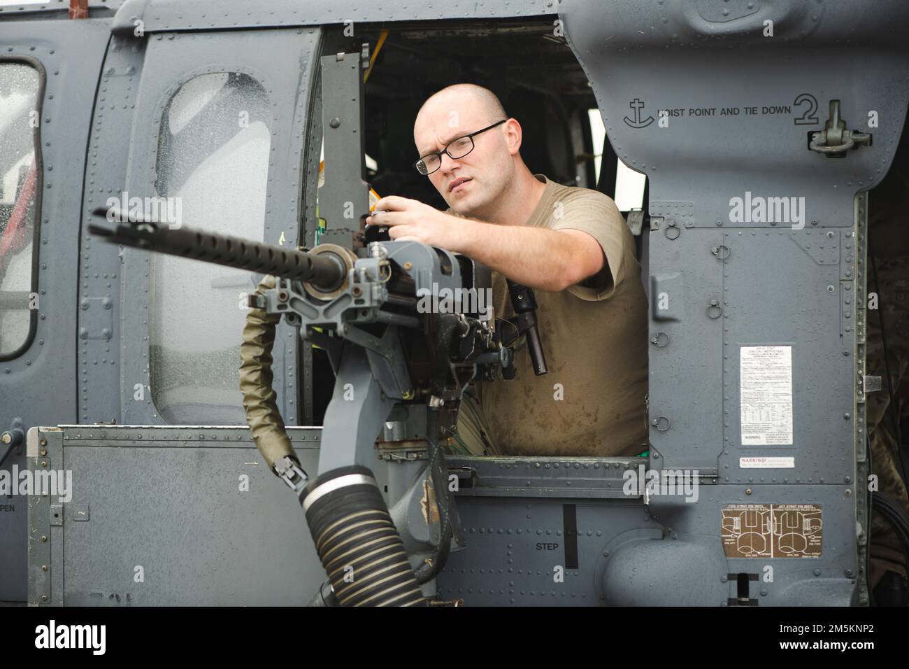 U.S. Air Force Tech. Sgt. Christopher Benson, 33rd Rescue Squadron weapons expediter, inspects a ...
