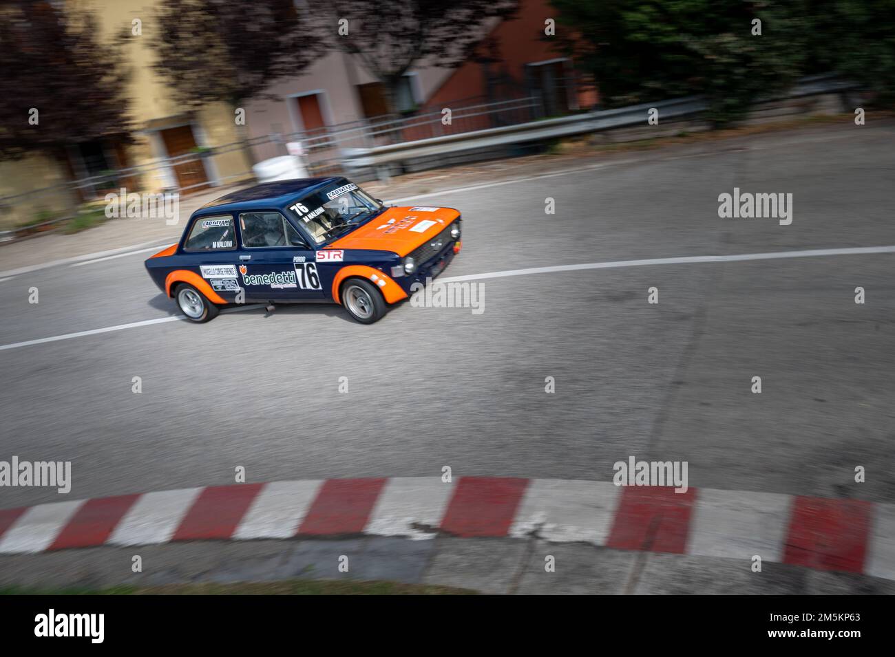 A blue and orange car set up during an uphill speed race of the Italian ...
