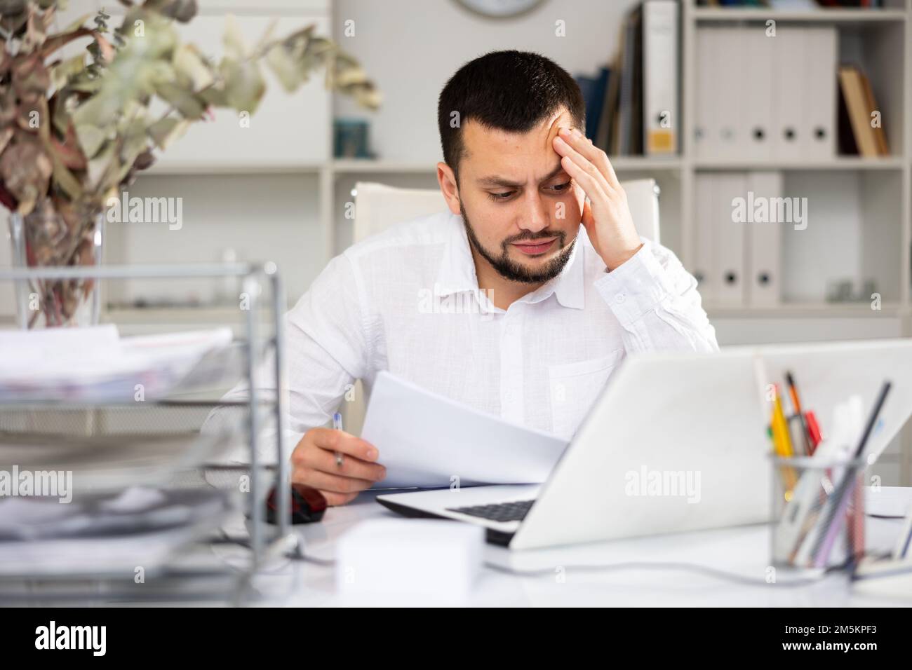 Sad tired male bookkeeper hi-res stock photography and images - Alamy