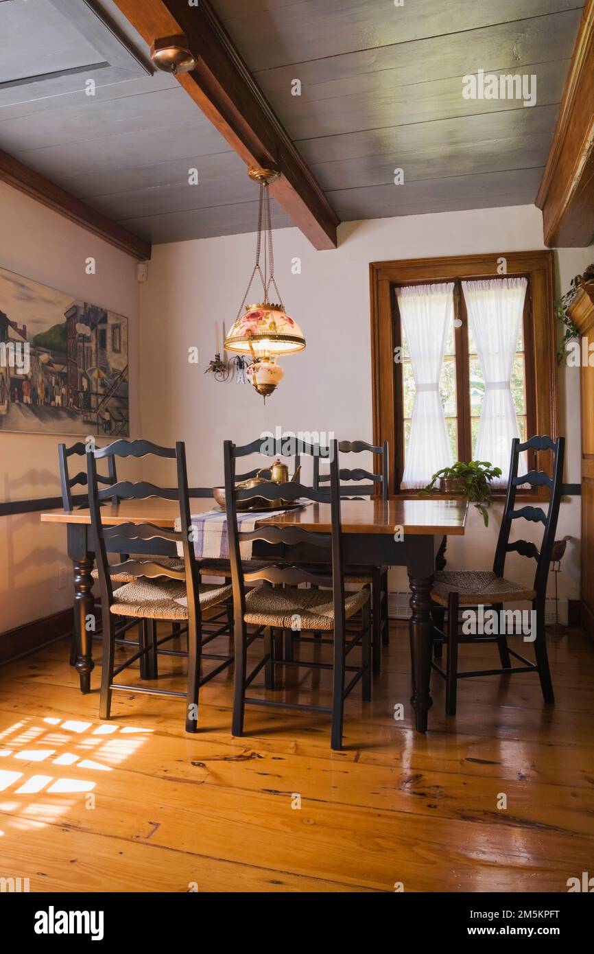 Antique wooden dining table with high back weaved seat chairs in dining ...