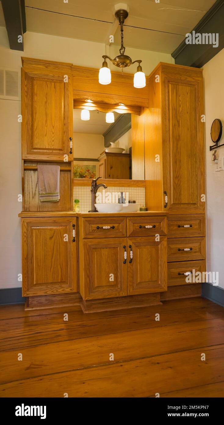 Wooden vanity with bowl sink and mirror in main bathroom inside ...