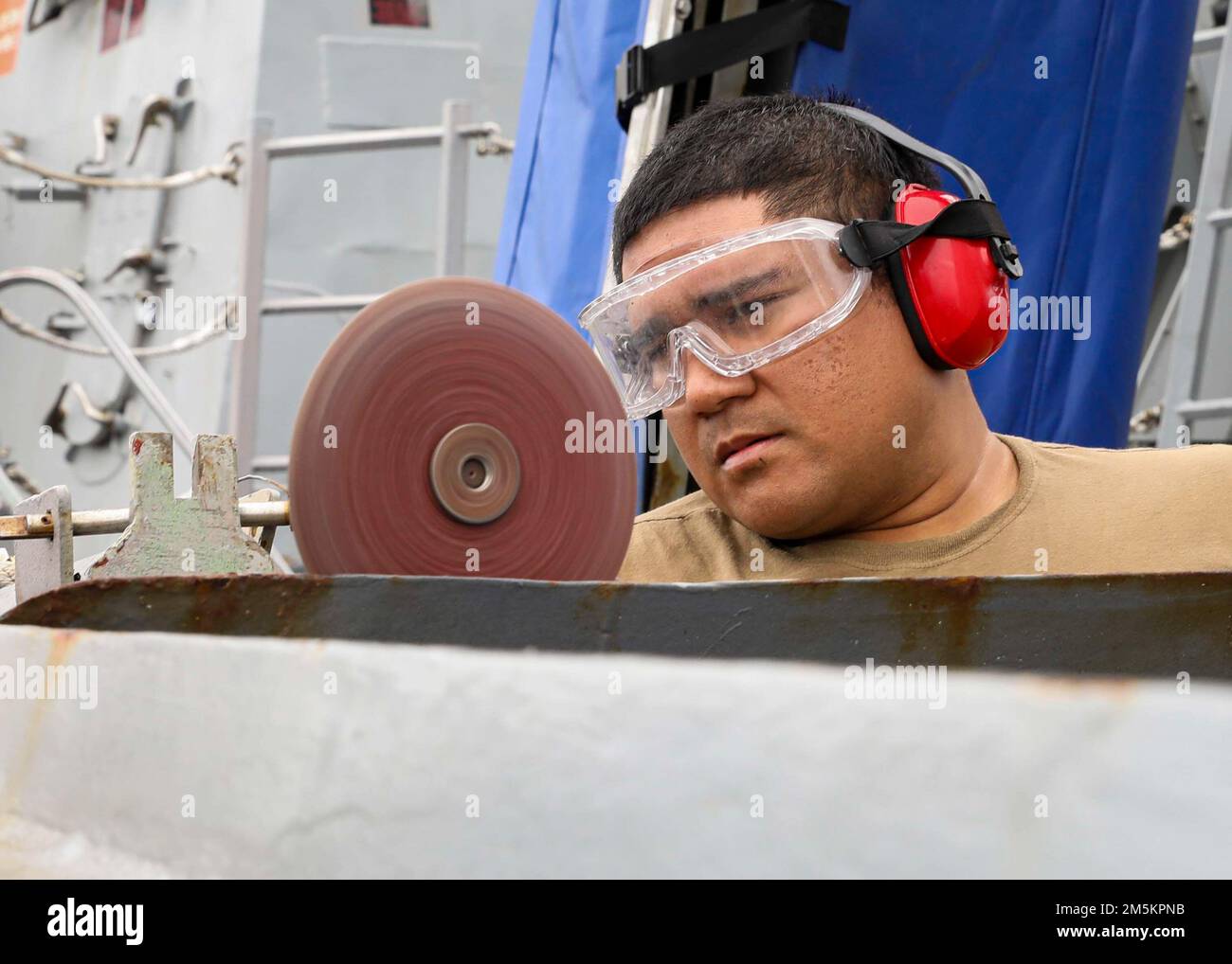 ATLANTIC OCEAN (March 23, 2022) – Seaman Misitamati Peau uses a sander ...