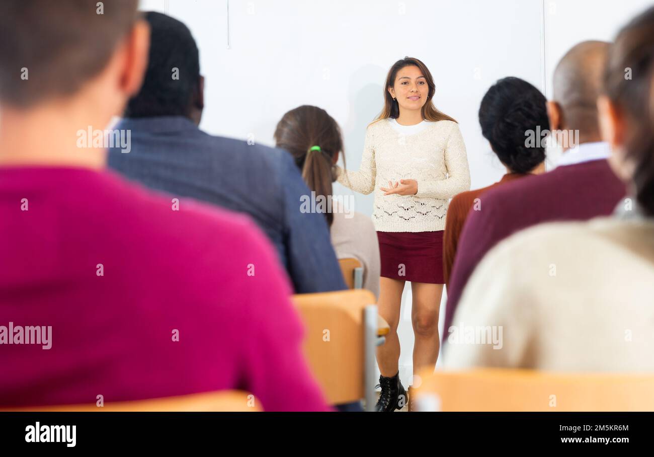 Teacher standing in front Of whiteboard and teaching lesson Stock Photo ...
