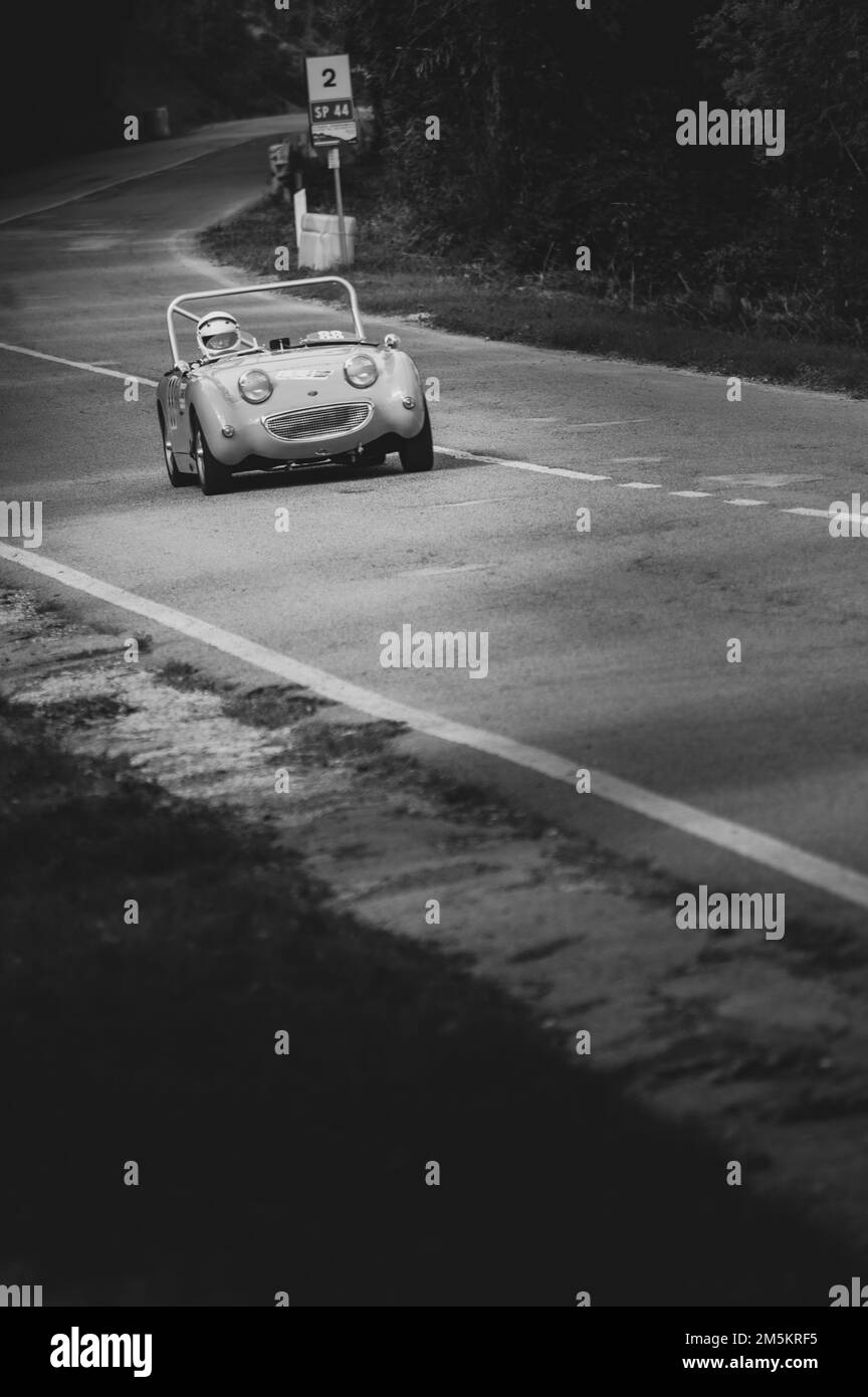 A greyscale of a car set up during an uphill speed race of the Italian ...