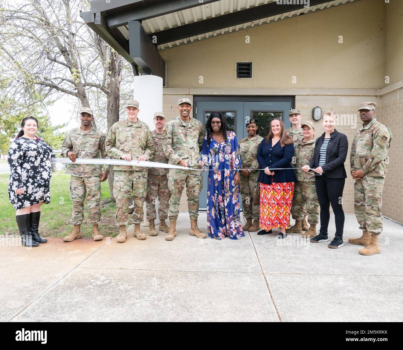 Members of the First Sergeants Council and Dover Spouses Club cut a ...