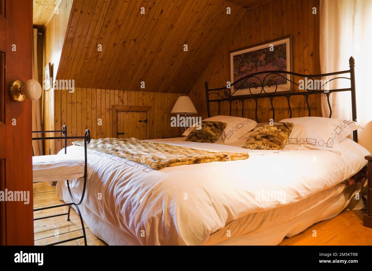 King size bed with wrought iron headboard in guest bedroom on upstairs ...