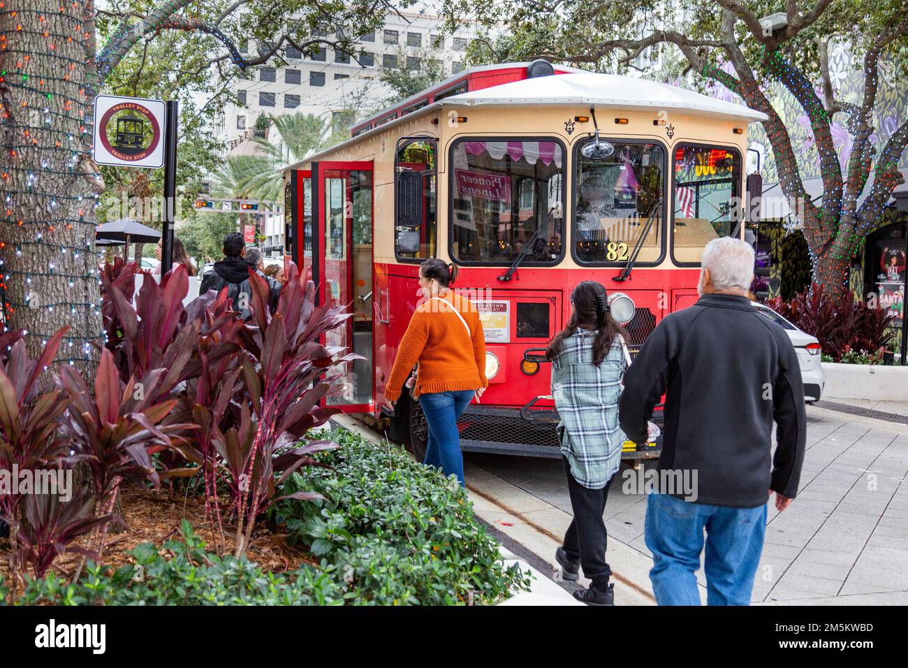 Passengers board the Downtown Trolley at a stop on Clematis Street in ...