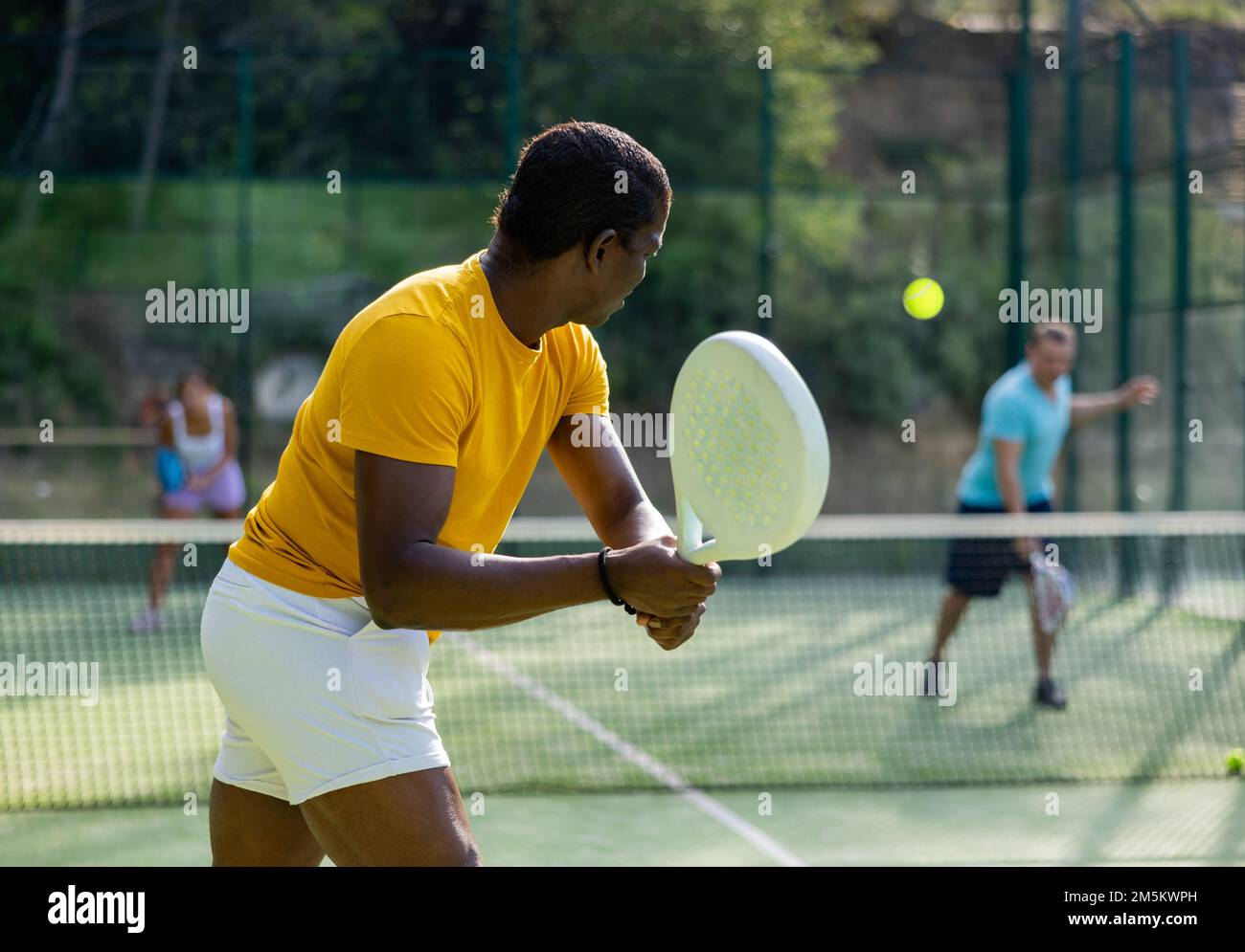 Rear photo of man playing padel tennis on court Stock Photo - Alamy