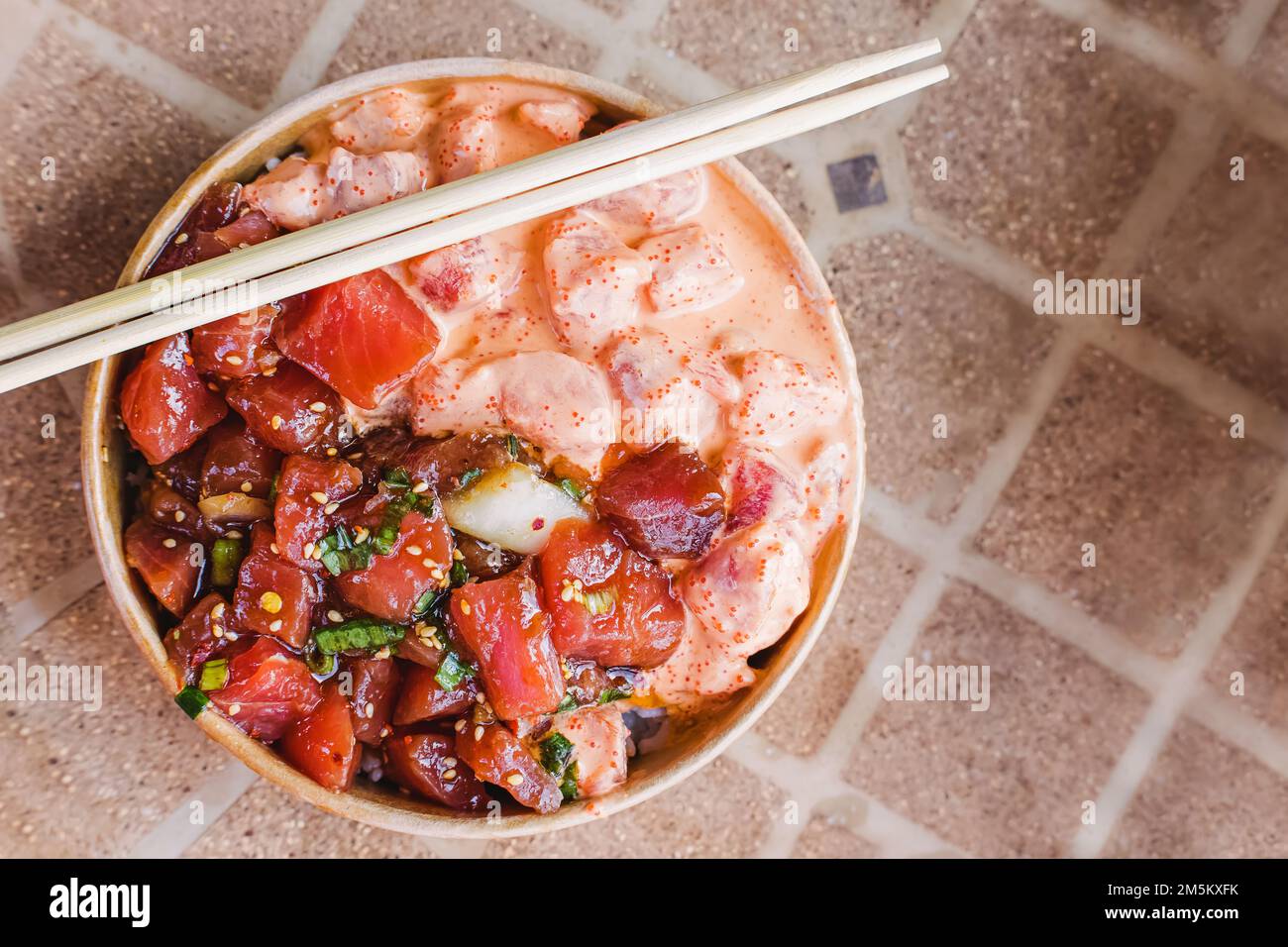 Two types of delicious traditional hawaiian poke in a paper bowl, top ...
