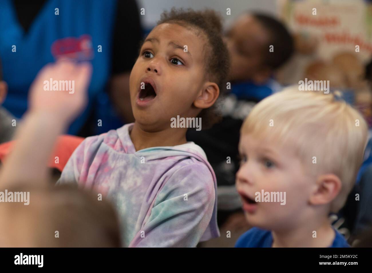 Children gasp in excitement as they listen to stories during the Women ...