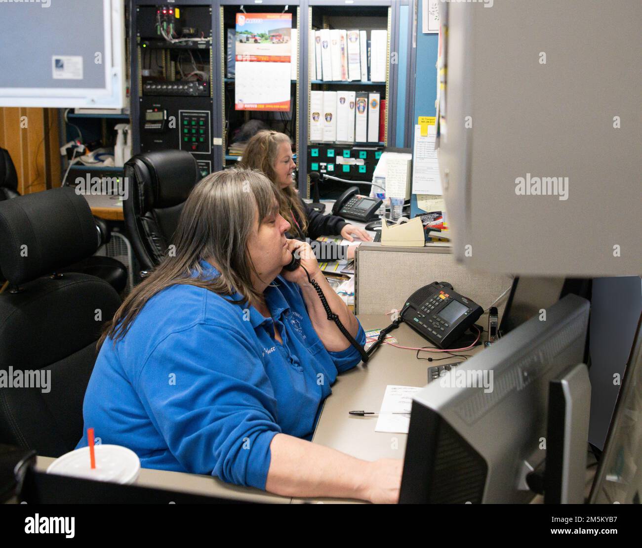Mitsy Pickett, front, an Emergency Communications Center operator with ...