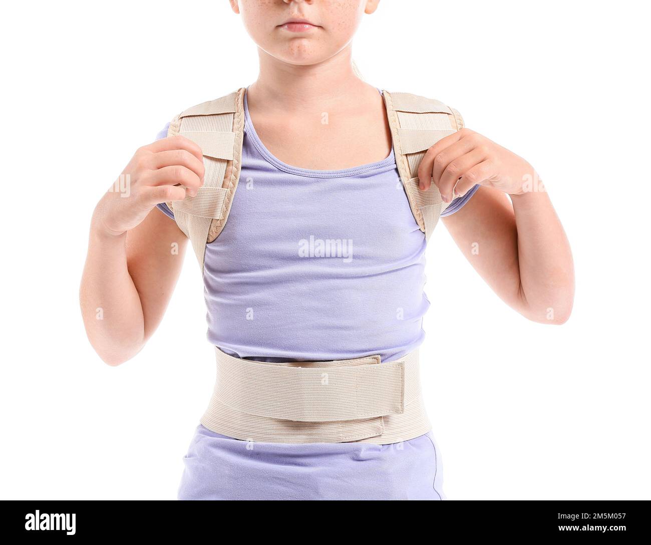 Little girl in back brace on white background Stock Photo - Alamy