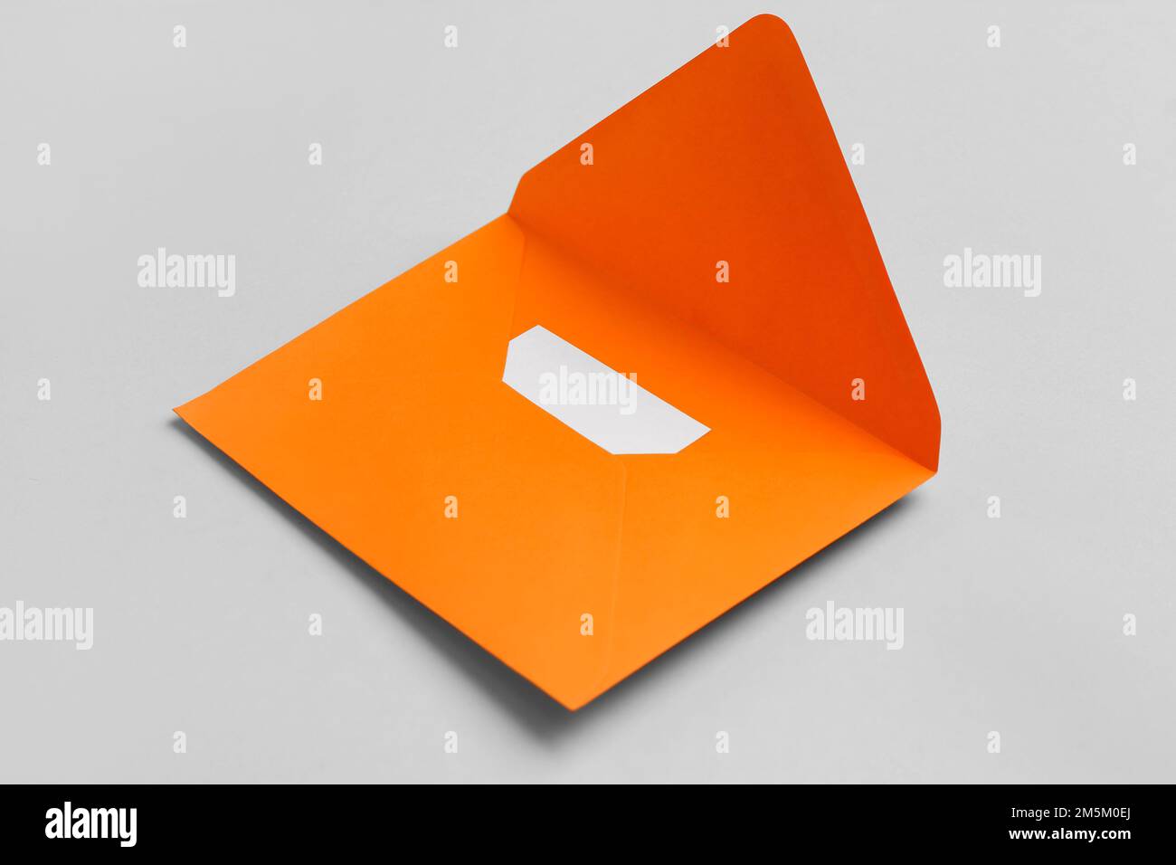 Orange envelope on grey background Stock Photo - Alamy