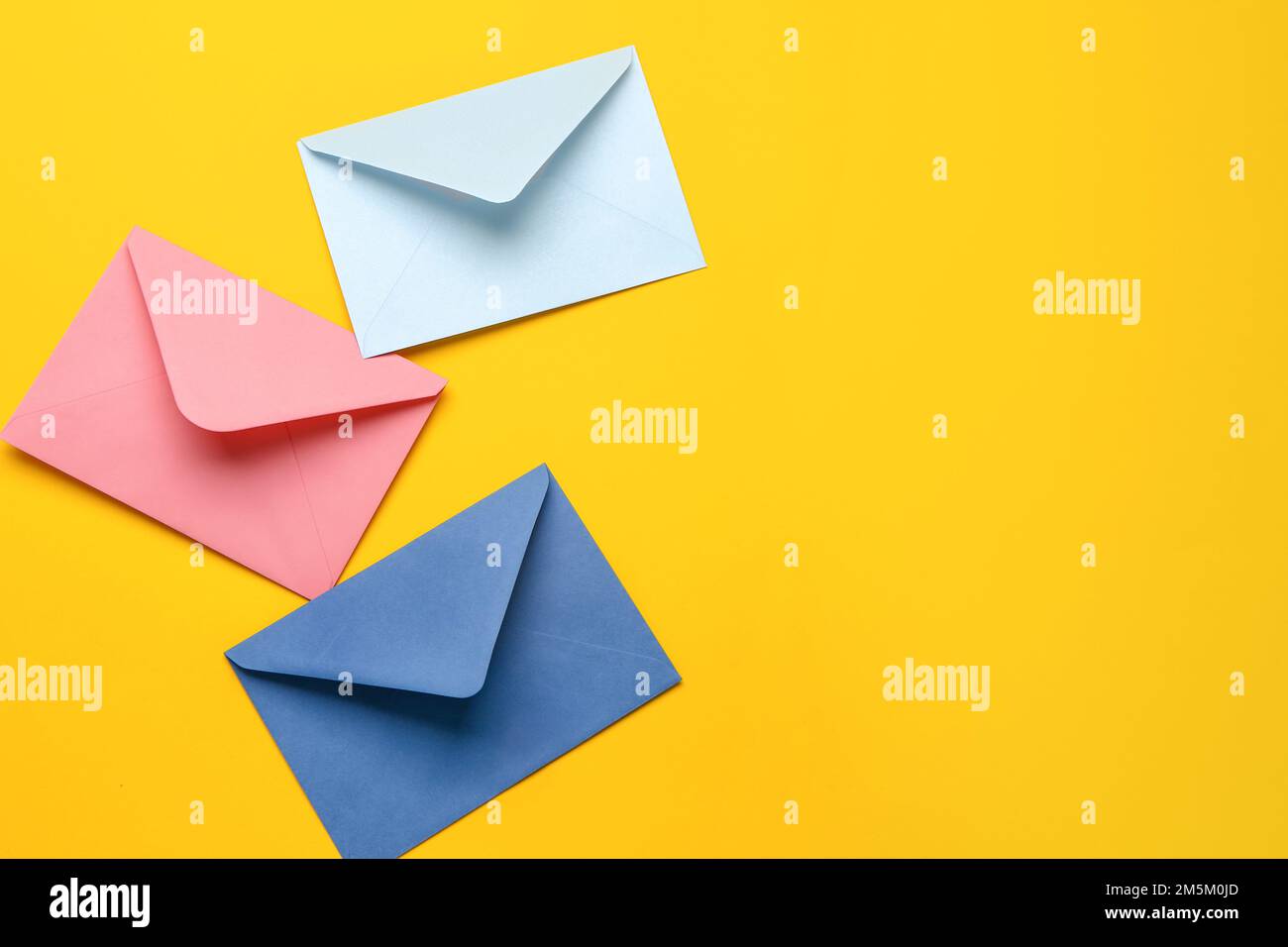 Colorful envelopes on yellow background Stock Photo - Alamy