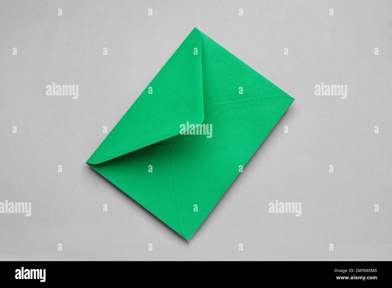 Green paper envelope on light background Stock Photo - Alamy