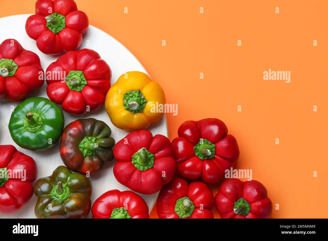 Plate with different bell peppers on color background, closeup Stock ...