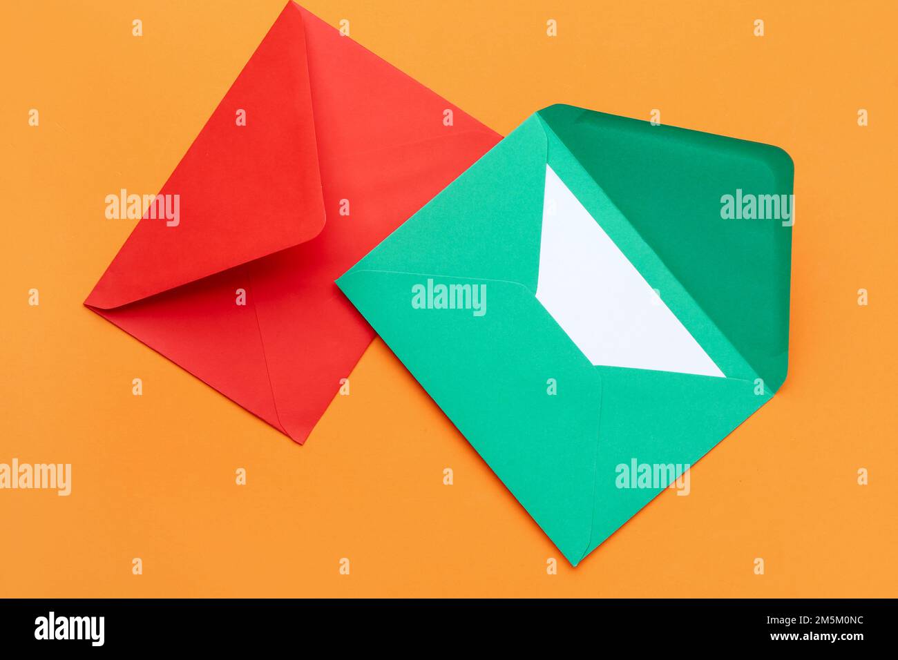 Red and green envelopes on color background Stock Photo - Alamy