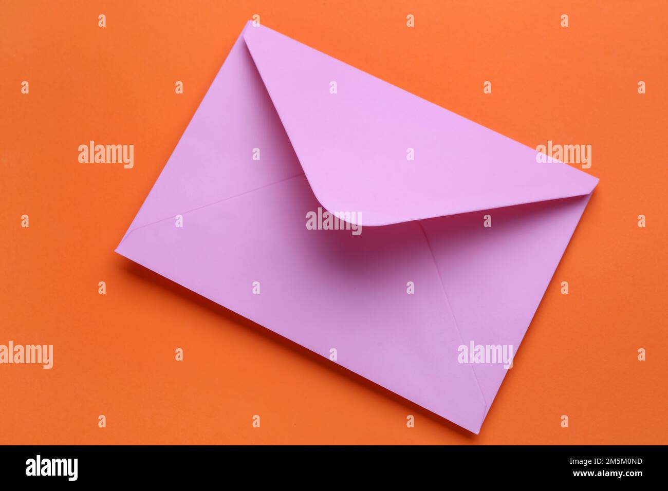Pink envelope on color background Stock Photo - Alamy