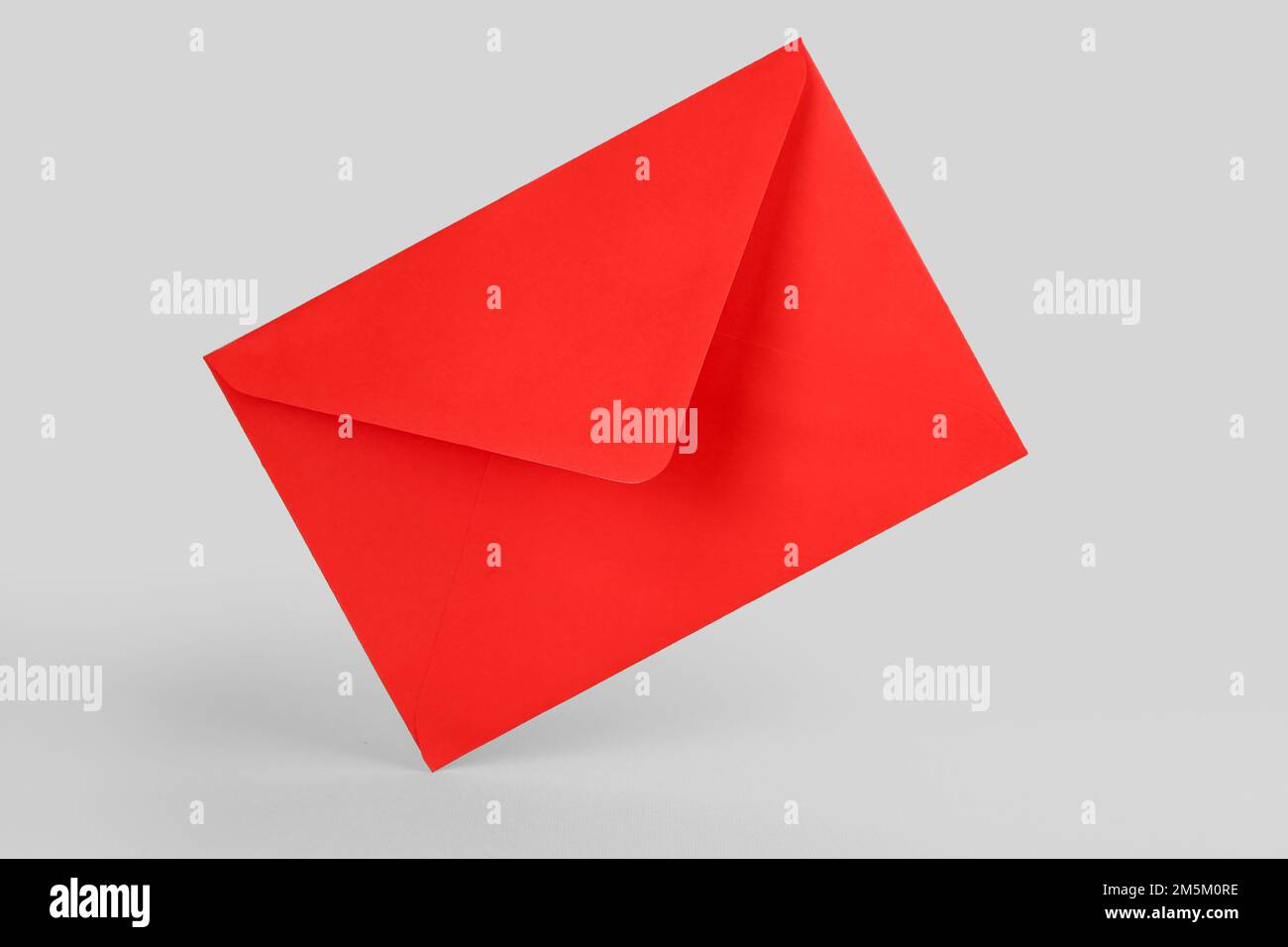 Red paper envelope on light background Stock Photo - Alamy