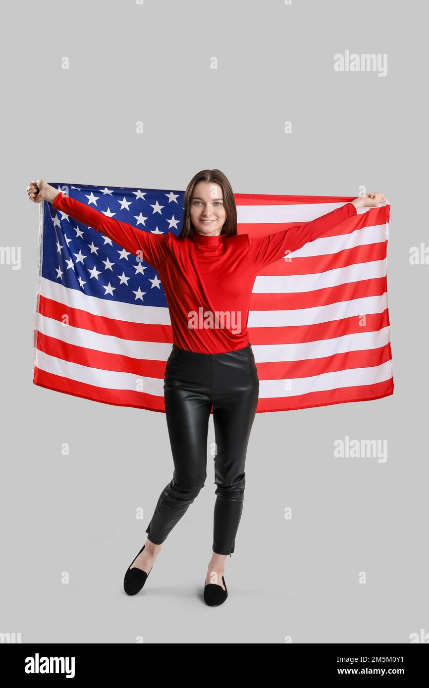 Young woman with USA flag on grey background Stock Photo - Alamy