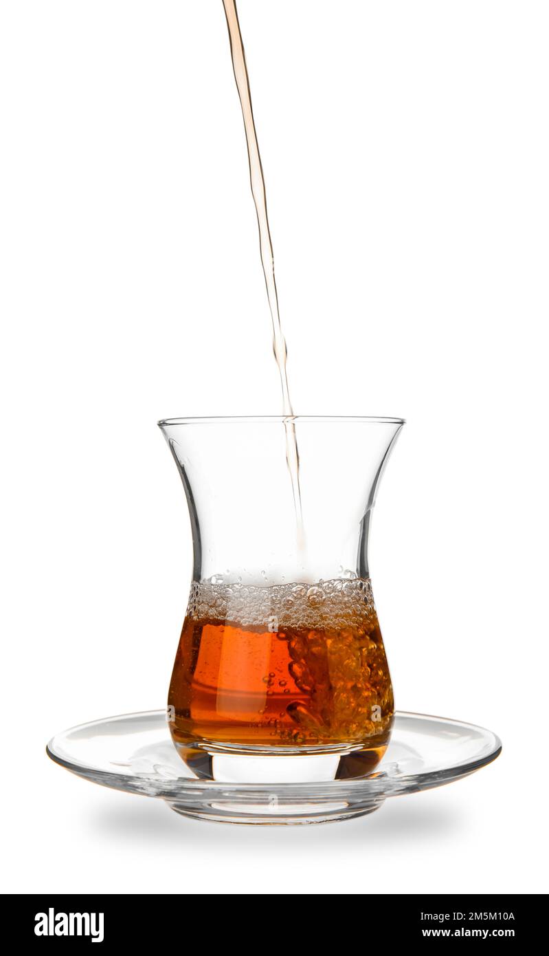 Pouring of Turkish tea into glass on white background Stock Photo - Alamy