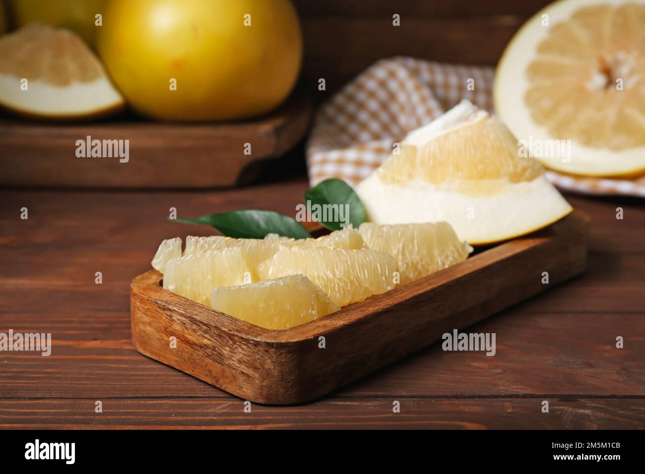 Sweet slices of pomelo fruit on wooden board, closeup Stock Photo - Alamy