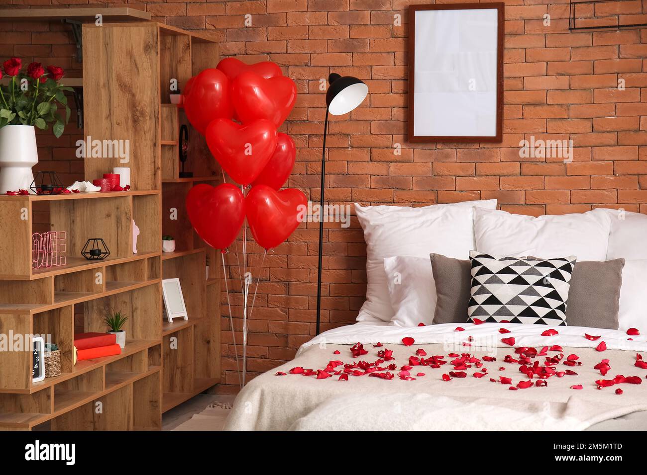 Interior of bedroom decorated for Valentine's Day with roses, shelving ...