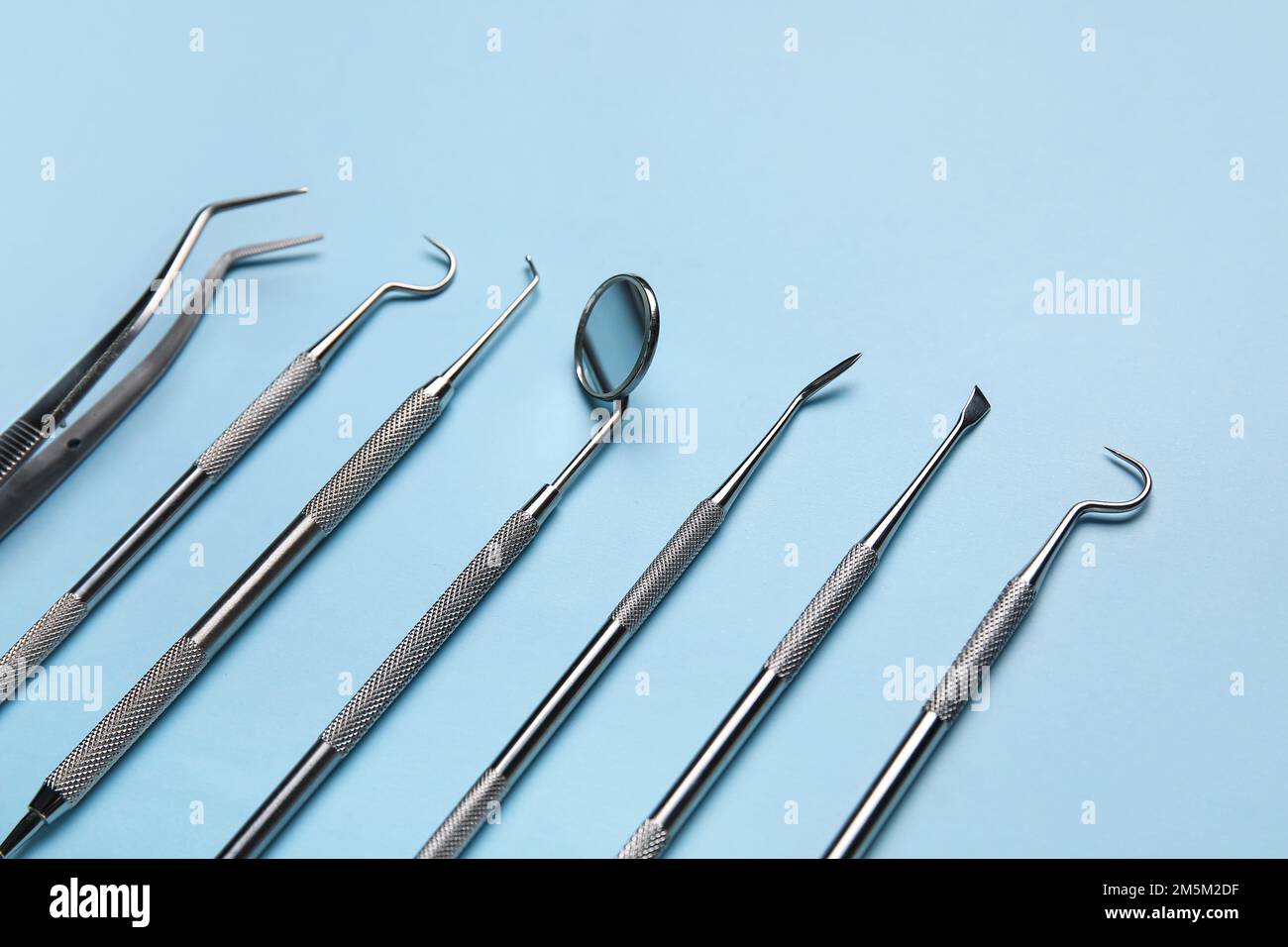 Different dental tools on blue background Stock Photo - Alamy